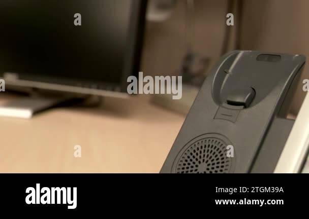 A close up of a hand picking up and slamming an office phone down a ...