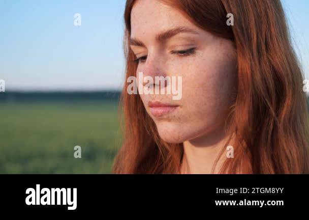 Beautiful female ginger face with freckles on nature at sunset. Woman ...