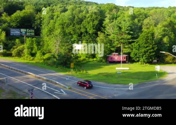 This video shows a view of a red caboose. A caboose is a railroad car ...