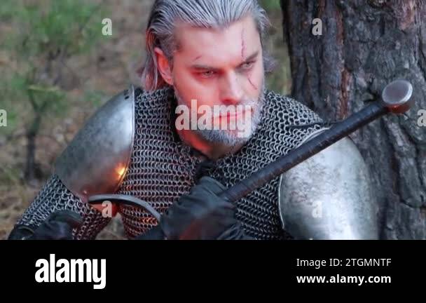 Portrait of a medieval warrior with gray hair and a scar on his face in ...