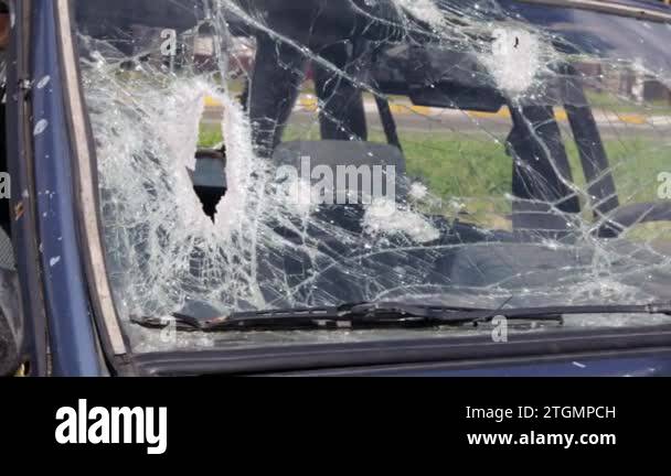 Holes on the windshield of the car, it was shot from a firearm. Bullet ...