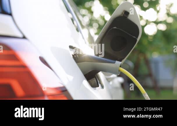Electric vehicle charging port plugging in EV modern car. Save ecology ...