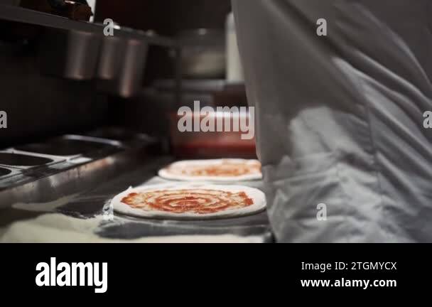 Pizza making process. Male chef hands making authentic pizza in the ...