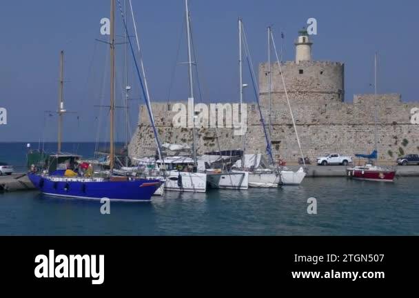 Ancient tower protecting the entrance to the port and the yachts ...