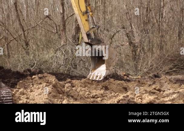 Working with backhoe by digging ground at construction site. Excavator ...