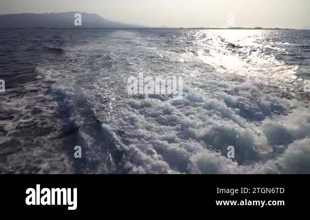 Blue ocean sea water wave with fast yacht boat wake foam of prop wash ...