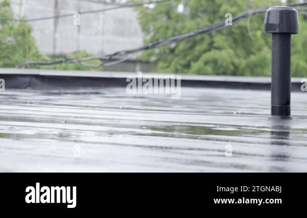 Raindrops knock on the roof, heavy rain, downpour. The flat roof of the ...