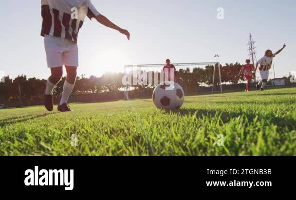 Video of diverse group of male football players playing football. Male ...