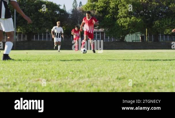 Video of diverse group of male football players playing football. Male ...