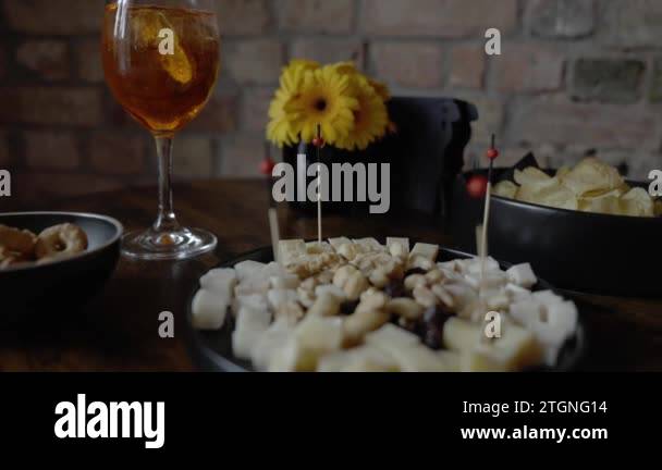 Traditional Italian aperitif with cheese, nuts and Aperol spritz drink ...