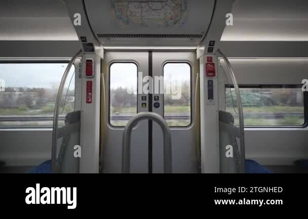 Inside sight of doors of commuter railway train during daytime with no ...