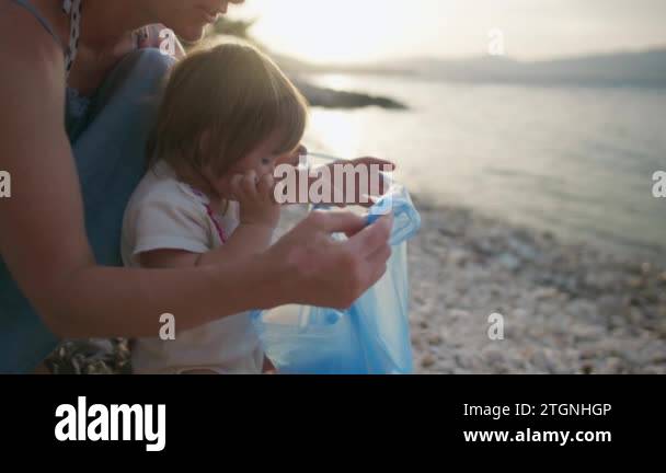 Mamaz child cleans garbage on the beach by the sea. Ecology and ...