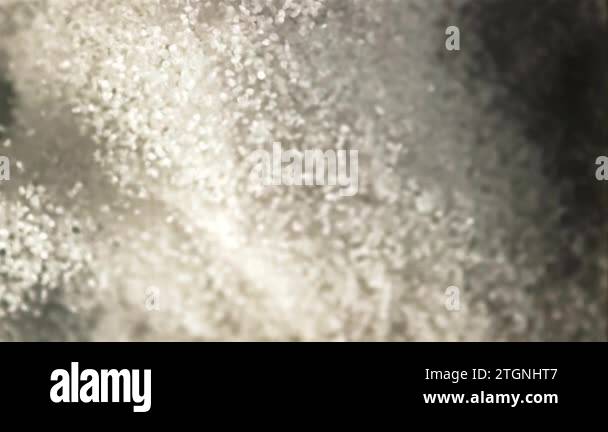 A bunch of sugar goes up and down. Macro background. Top view. The ...