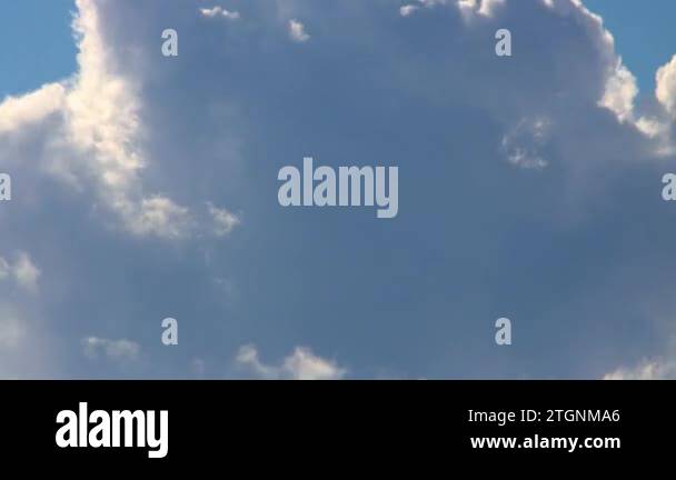 Fluffy cumulus clouds zoomed in close up and sped up in a timelapse ...