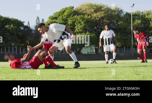 Video of diverse group of male football players playing football. Male ...