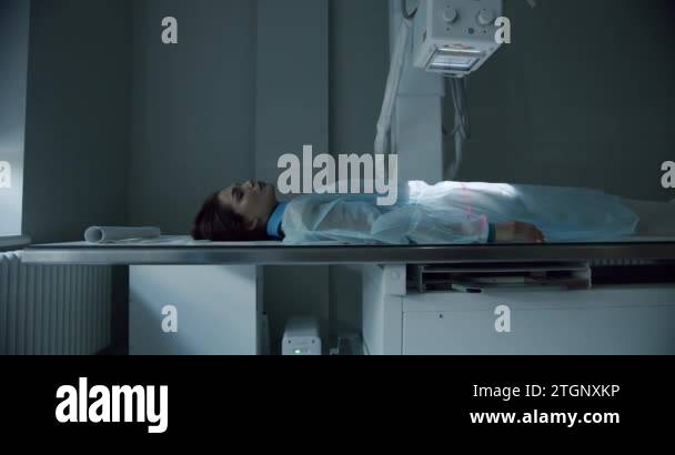 Female patient on X ray machine. Pan left and right view of woman in ...