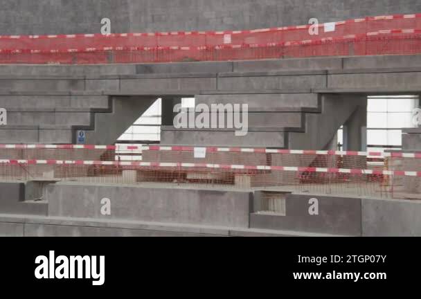 Concrete foundation of spectator places and red fences at hockey ...