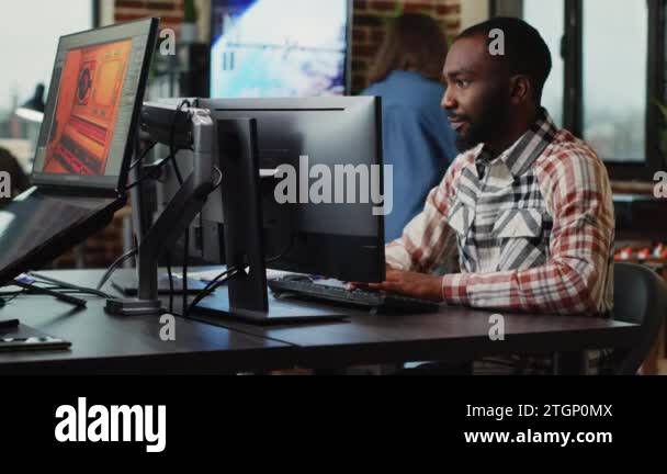 Multiethnic group of employees creating 3d project at office workstation, using multiple ...