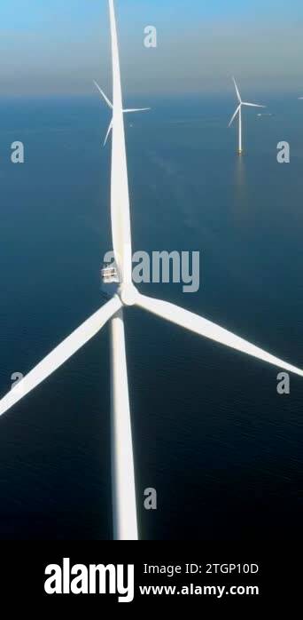 Drone view at wind mill turbines, Windmill park with clouds and a blue ...