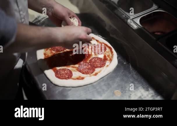 Pizza making process. Male chef hands making authentic pizza in the ...