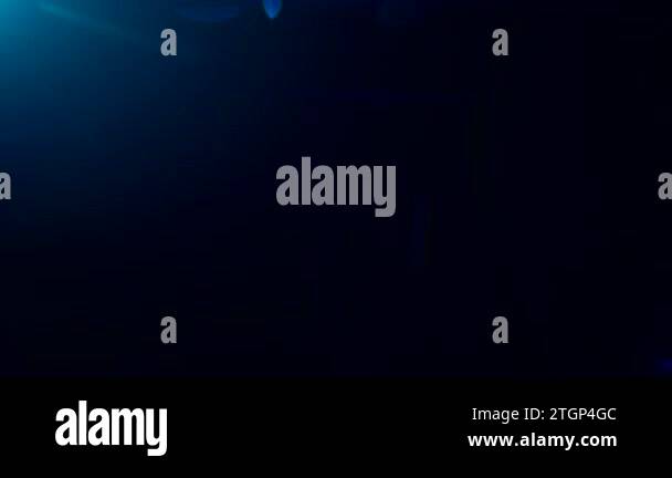 Anamorphic blue beam flare on left side of frame moves from top to ...