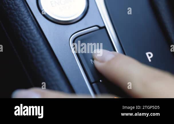 Pressing the MODE button inside an electric car to activate the ...