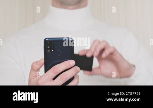 Scanning QR code with a modern cold crypto wallet and smartphone. Young ...