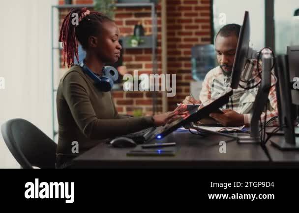 African american team of employees wokring on creative production, having artistic 3d ...