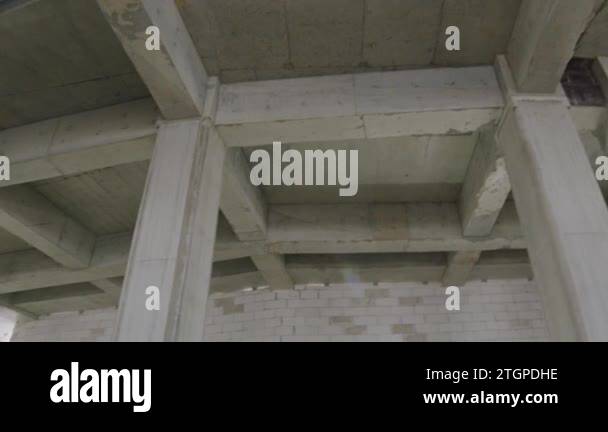 Concrete carcass and brick walls in sports stadium building hall. Inner ...