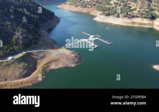 Aerial flyover of a small Moccasin Point Marina. Lake in the California ...