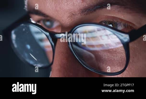 Close up business male face in eyeglasses working computer late ...