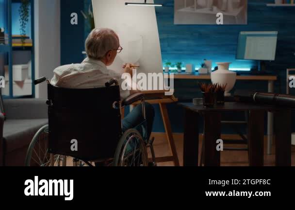 Senior adult with chronic impairment using pencils to draw vase model ...