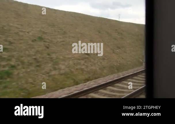 View on railroad track from the window of fast train. 4K Interior view ...