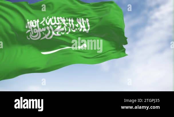 Saudi Arabia national flag waving in the wind on a clear day. Green ...