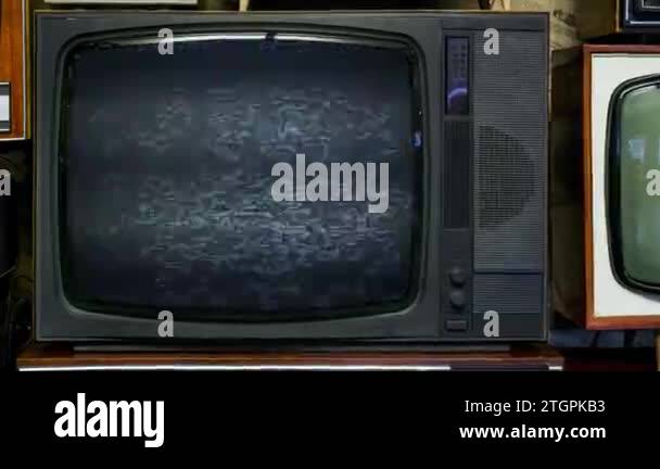 Old retro television with grey interference screen and switching to ...