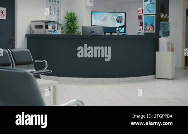 No people in waiting area with reception counter desk at medical clinic ...