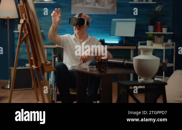 Old person with disability in wheelchair using vr glasses to draw professional artwork ...