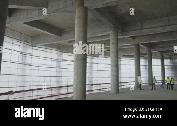 Inspectors in uniform checkup unfinished stadium building standing in ...
