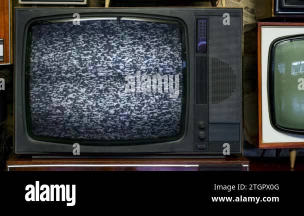Old retro television with grey interference screen and switching to ...