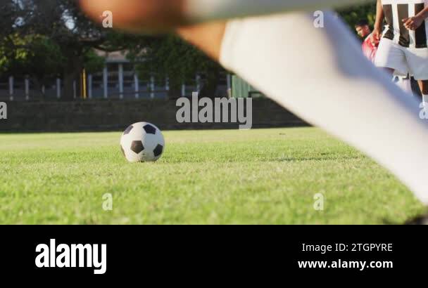 Video of diverse group of male football players playing football. Male ...