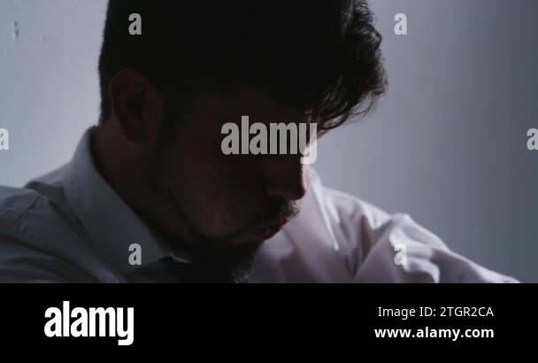 A businessman having a nervous breakdown on the floor and laughing ...