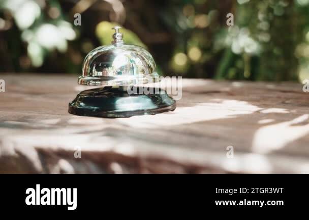 Hospitality hotel. Customer hand ringing service bell at coffee cafe ...