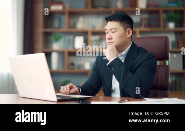 Portrait thoughtful asian male businessman working on pc laptop ...
