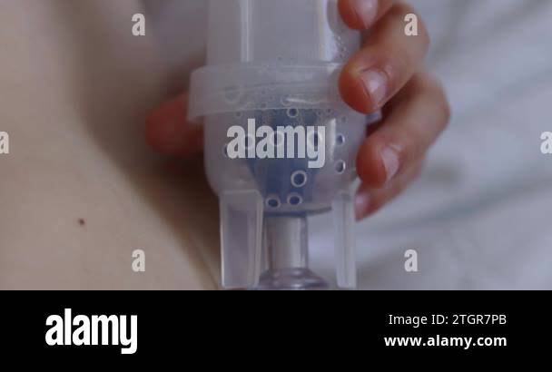 Cute caucasian little girl with mask breathes through an inhaler. Home ...