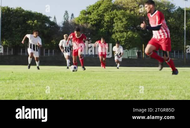 Video of diverse group of male football players on field, playing ...