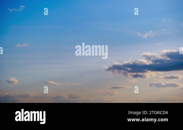 Clouds in the blue sky slowly move and change shape, Timelapse. Layered ...