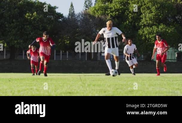 Video of diverse group of male football players on field, playing ...