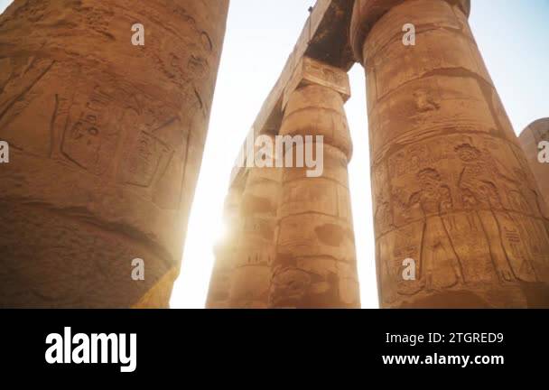 Massive pillars with intricate carved images and hieroglyphs in the ...