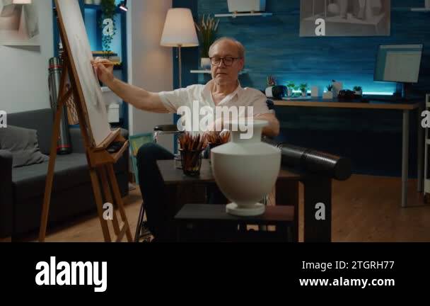 Male wheelchair user with impairment drawing vase model for art and ...