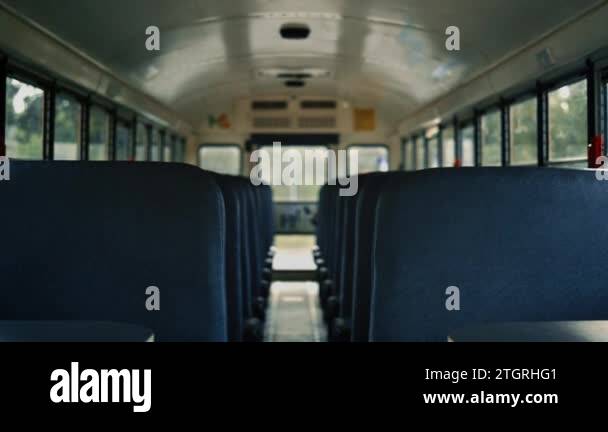 Empty school bus saloon with comfortable blue seats close up. View of ...